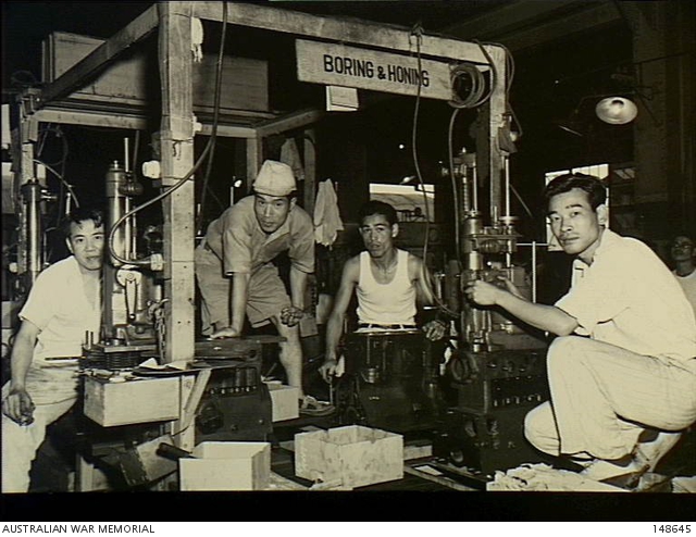 Kure, Japan. 1953-09. Japanese civilian employees inspecting the boring ...