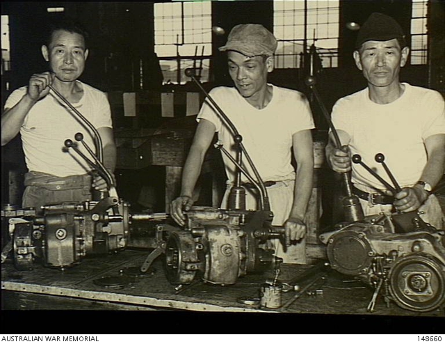 Kure, Japan. 1953-09. Japanese civilian employees repairing gear boxes ...
