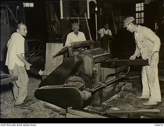 Kure, Japan. 1953-09. Japanese civilian employees working on a machine ...