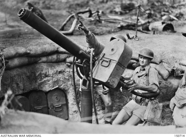 NT. October 1942. An Australian gunner, under instruction from a US ...