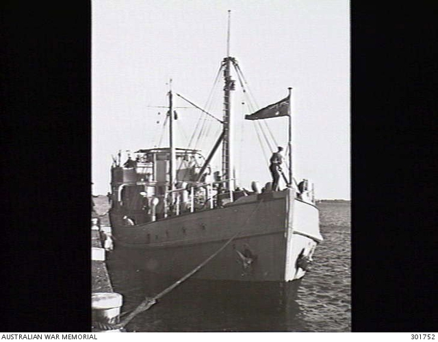 STARBOARD BOW VIEW OF THE ARMAMENT STORE-CARRIER HMAS WOOMERA ALONGSIDE ...