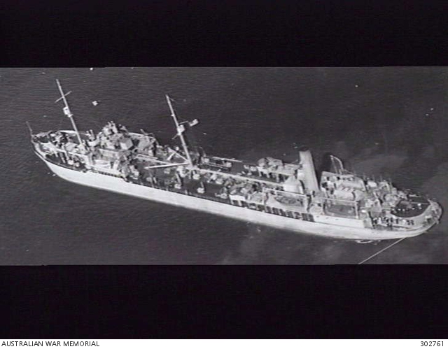 1942-07-13. AERIAL PORT SIDE VIEW OF THE USS TRINITY (AO-13) SHOWING ...