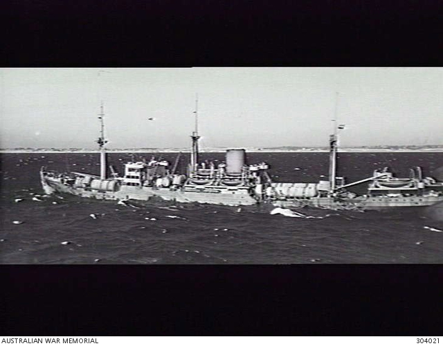 AERIAL PORT SIDE VIEW OF THE DUTCH CARGO VESSEL TARAKAN. THE GUN ...