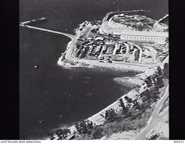 DARWIN, NT. 1946-02. AERIAL VIEW OF DARWIN SHOWING THE TANK JETTY, BOOM ...