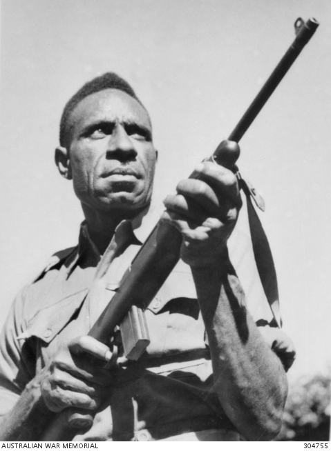 Portrait of Simogun Pita, a New Guinea native coastwatcher, armed with ...