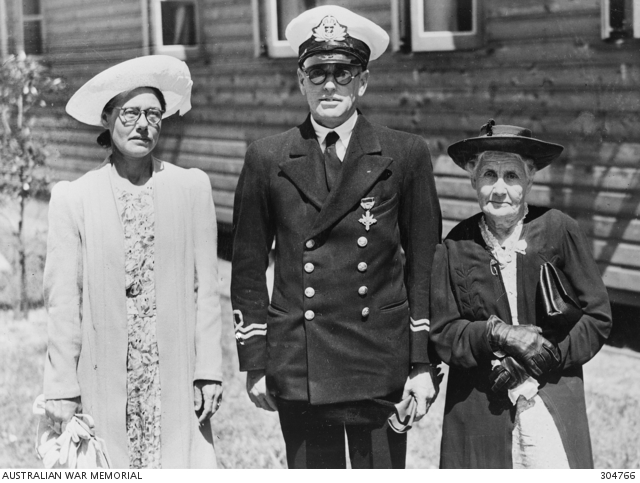 LIEUTENANT P E MASON RANVR WITH FAMILY MEMBERS AFTER THE PRESENTATION ...
