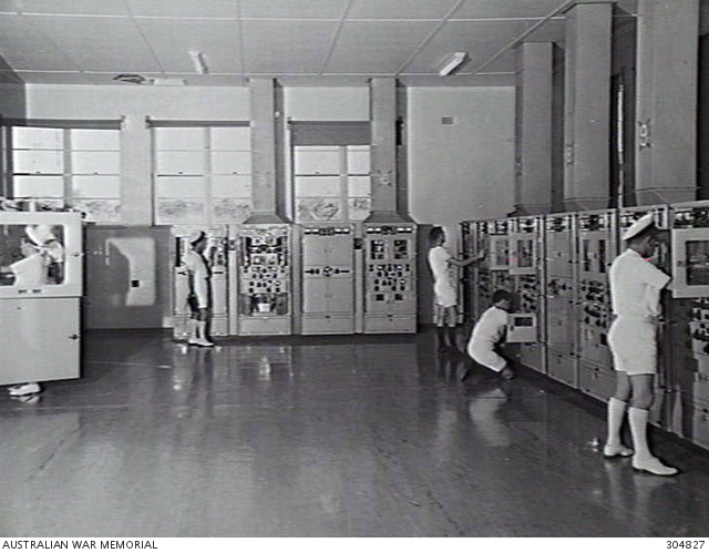 HMAS HARMAN, CANBERRA, ACT. A BATTERY OF CONSOLES CONTAINING ELECTRICAL ...