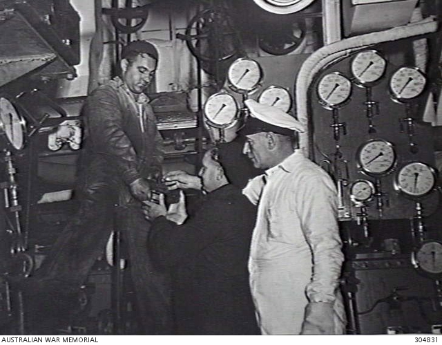 SURROUNDED BY GAUGES, ENGINE ROOM STAFF CARRY OUT MAINTENANCE WORK IN ...