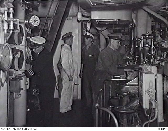 ENGINE ROOM STAFF CARRYING OUT THEIR DUTIES IN THE ENGINE ROOM OF AN ...