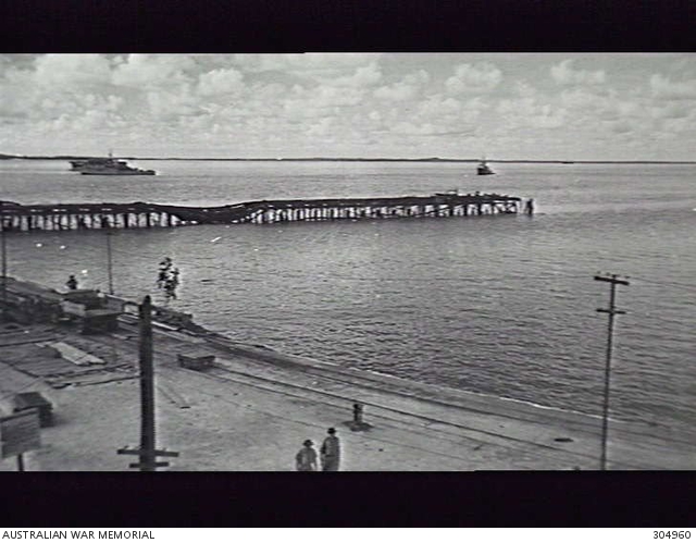DARWIN, NT. 1942-02-19. THE MAIN PORTION OF THE PIER, DAMAGED AND ...