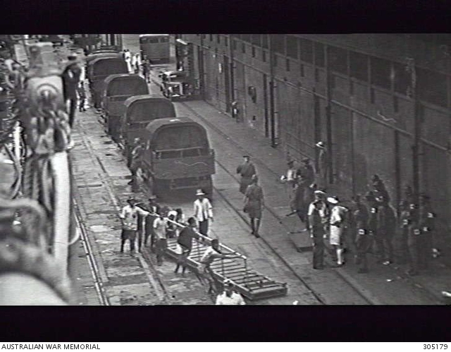 BATAVIA, JAVA. 1942-02-04. MEDICAL PERSONNEL AND MOTOR TRANSPORT WAIT ...