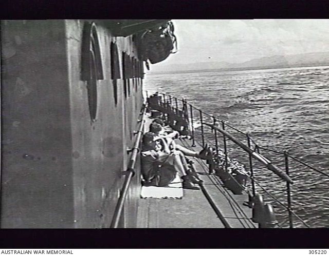 1944-09. HMAS ARUNTA FROM WAIST LOOKING AFT. MEMBERS OF THE SHIP'S ...