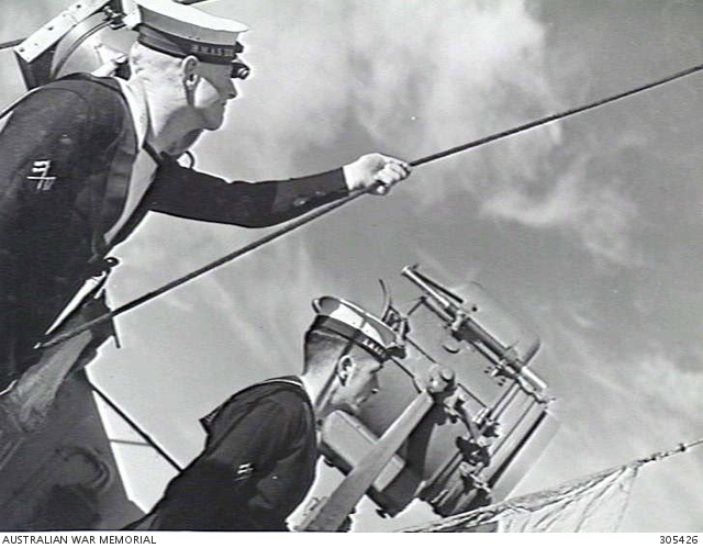 C.1940. HOISTING SIGNAL FLAGS ALOFT ON THE AUXILIARY ANTI SUBMARINE ...