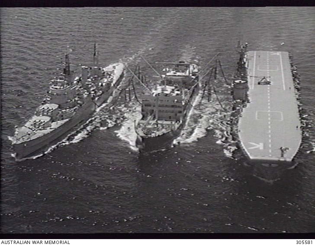 1956-10-07. AERIAL BOW VIEW OF THE CRUISER HMS NEWCASTLE AND THE ...
