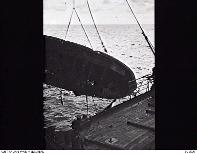 A lifeboat from the German raider Kormoran being winched on board the ...