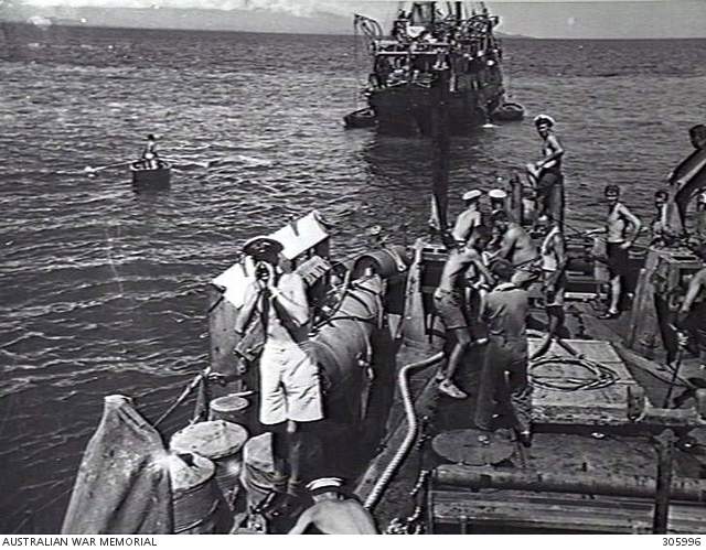 COLLINGWOOD BAY, NEW GUINEA. THE CORVETTE HMAS BROOME PREPARING TO TOW ...