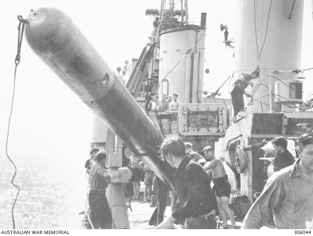 KOREA. C.1951. A PRACTICE TORPEDO IS RETRIEVED AND HOISTED ON BOARD ...