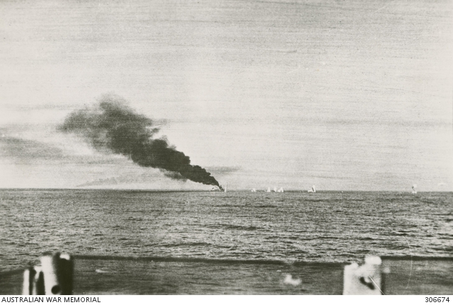 SEEN FROM THE CRUISER HMAS SYDNEY (II), SHELL SPLASHES LAND NEAR THE ...