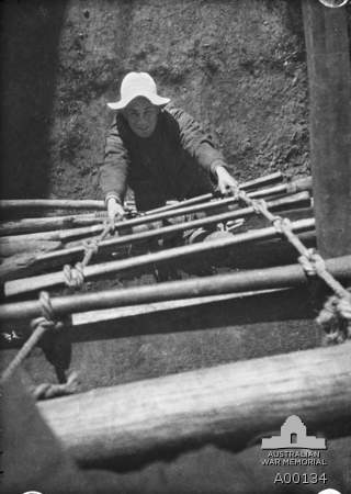Sapper Thompson climbing up the rope ladder to the top of the signal ...