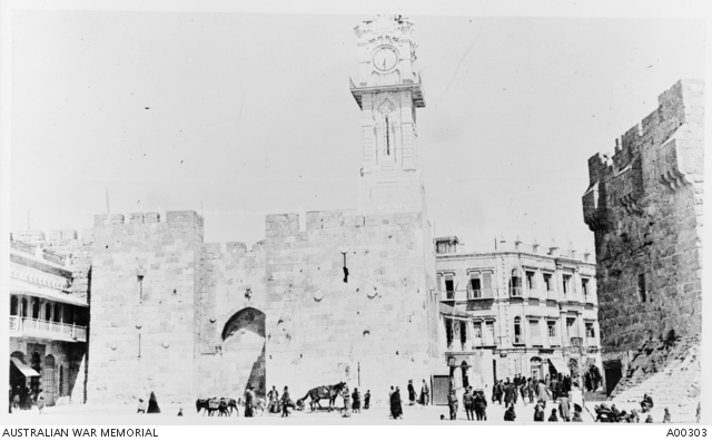 View of Jaffa Gate and clock tower. Local people are in the street ...