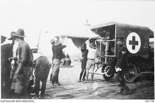 A patient being transferred into an ambulance from the hospital ship ...