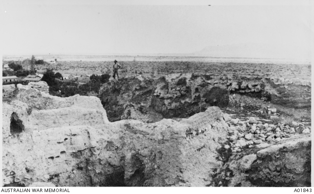 Ruins of ancient Jericho. A soldier is standing in the middle ground ...