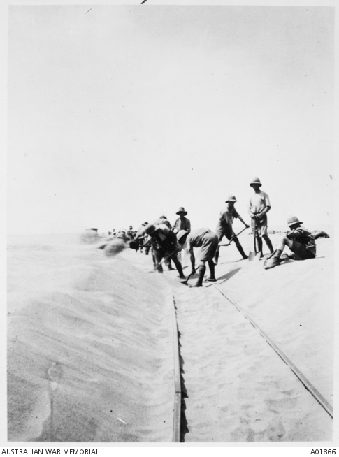 Soldiers clearing the rail line after a sand storm. | Australian War ...