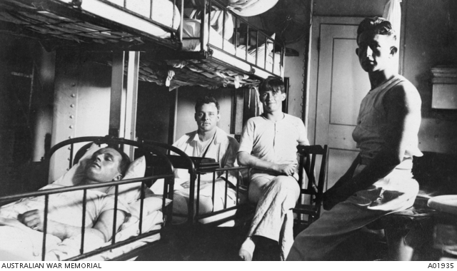 Three unidentified patients and a sick berth attendant in a sick bay ...