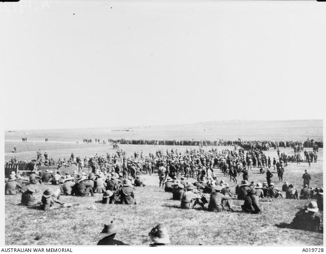 Spectators at a race meeting at Rafa. This is the centre image in a ...