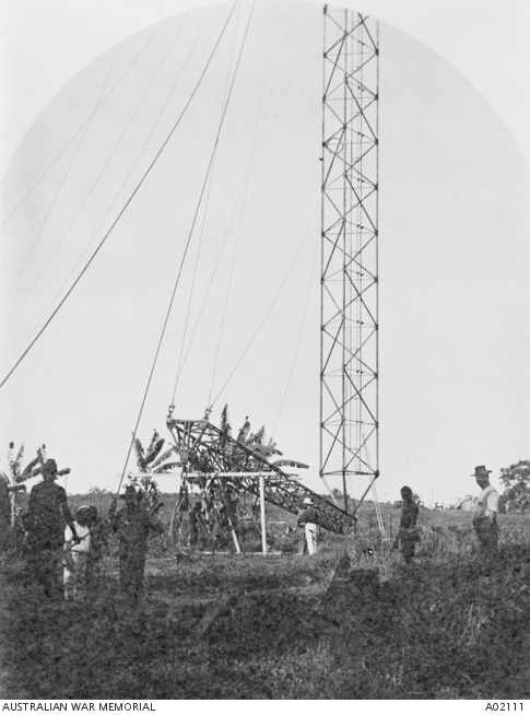 Soldiers and local men erecting the wireless aerial at Bitapaka, about ...