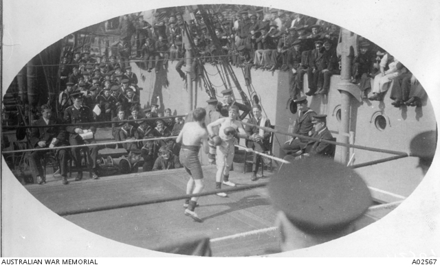 Officers and sailors watching a Boxing Tournament alongside HMAS Sydney ...