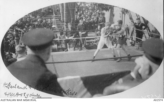 Officers and sailors watching a Boxing Tournament alongside HMAS Sydney ...
