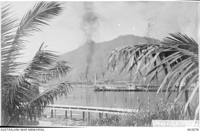 HMAS Melbourne steaming alongside the jetty at Rabaul. A bridge or ...