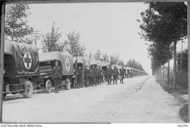 A long motor ambulance convoy stopped along a main French road. Two of ...