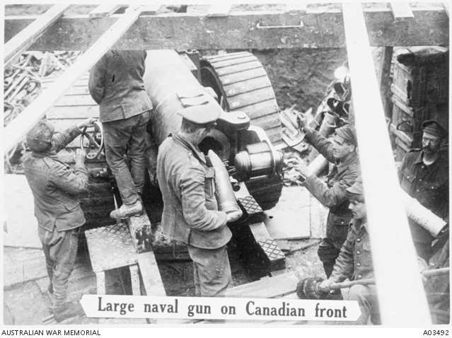Artillerymen loading a large naval gun on the Canadian front ...