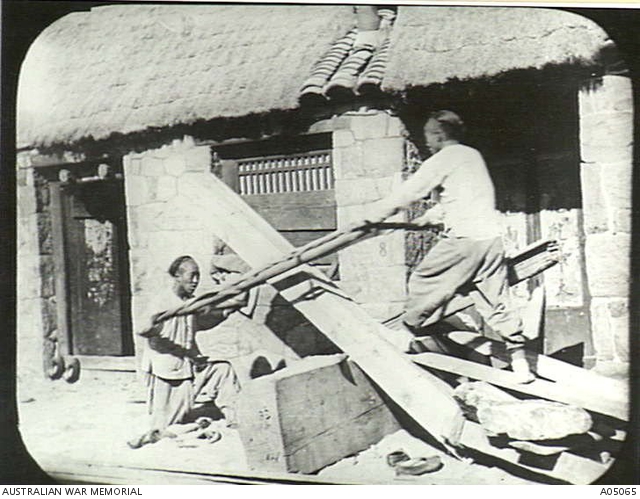 Two Chinese carpenters workings with traditional tools of the period in ...