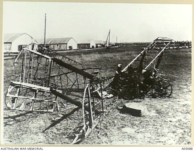 THE REMAINS OF A CRASHED BIPLANE. ONLY THE GUNS, ROTARY ENGINE, AND ...