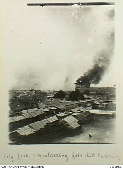 PEKING, CHINA. 1900. THE CHIEN MEN GATE FIRE STRONGLY ALIGHT WHILE THE ...