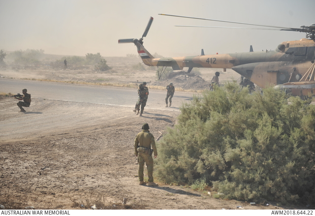 An Australian Army Officer from Task Group observes initial air ...