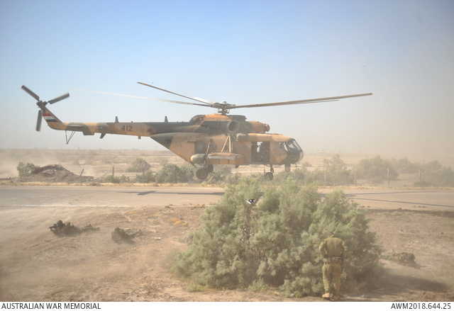 An Iraqi MI-17 lifts off while Iraqi Rangers provide security during an ...