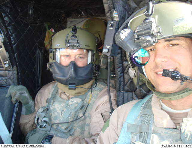 Aircrewman Cpl Richard ‘Scooter ‘Wakelin kneeling in the companion way ...