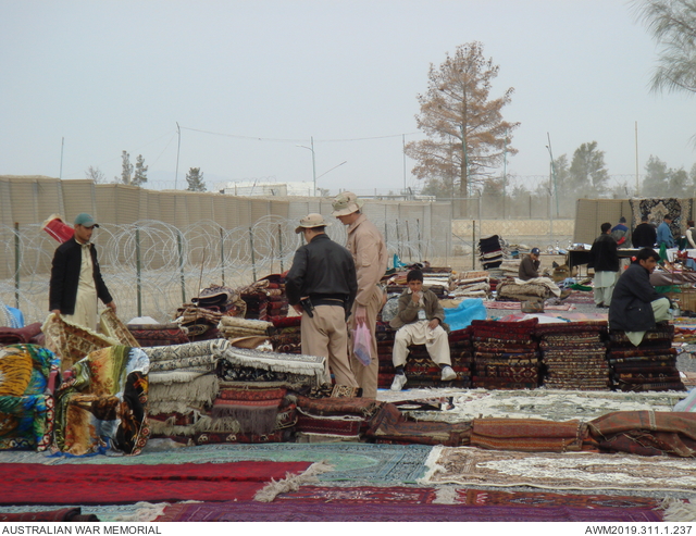 Australian servicemen browse the rug stalls at the Kandahar Boardwalk ...
