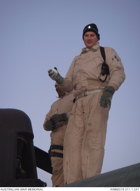 Cpl Richard Waklelin prepares to throw a handful of ice collected ...