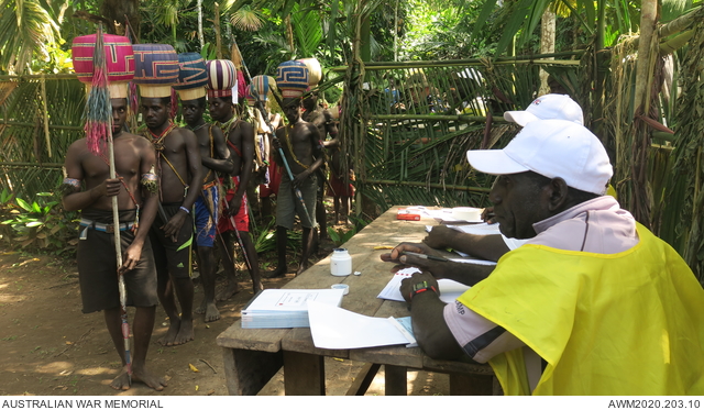Boys wearing the Upe hat of initiation arrive in a village to vote in ...