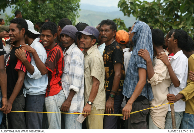 Men lining up in a polling booth to vote in the first round of the East ...