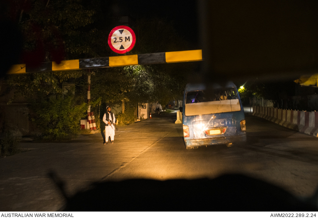 A mini-bus convoy loaded with Afghan evacuees approaches a Taliban ...