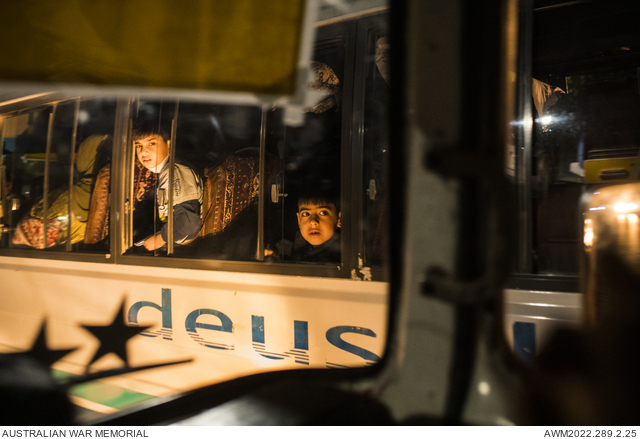 A mini-bus convoy loaded with Afghan evacuees drives through Kabul from ...