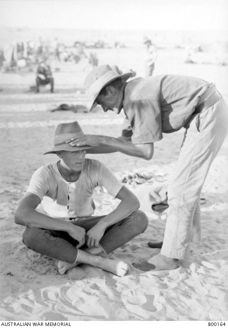 Fitting puggaree on hat of Trooper Tom Geddes, left, of the 7th ...