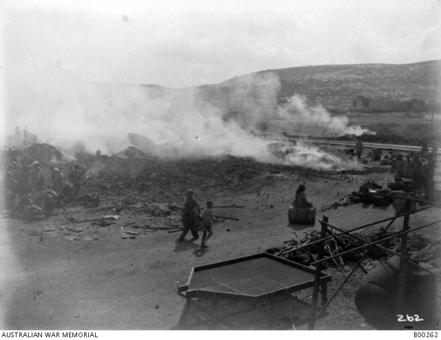 A dump on fire on either side of the railway line. | Australian War ...