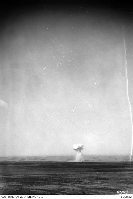Exploding captured ammunition, the shellburst visible some distance ...